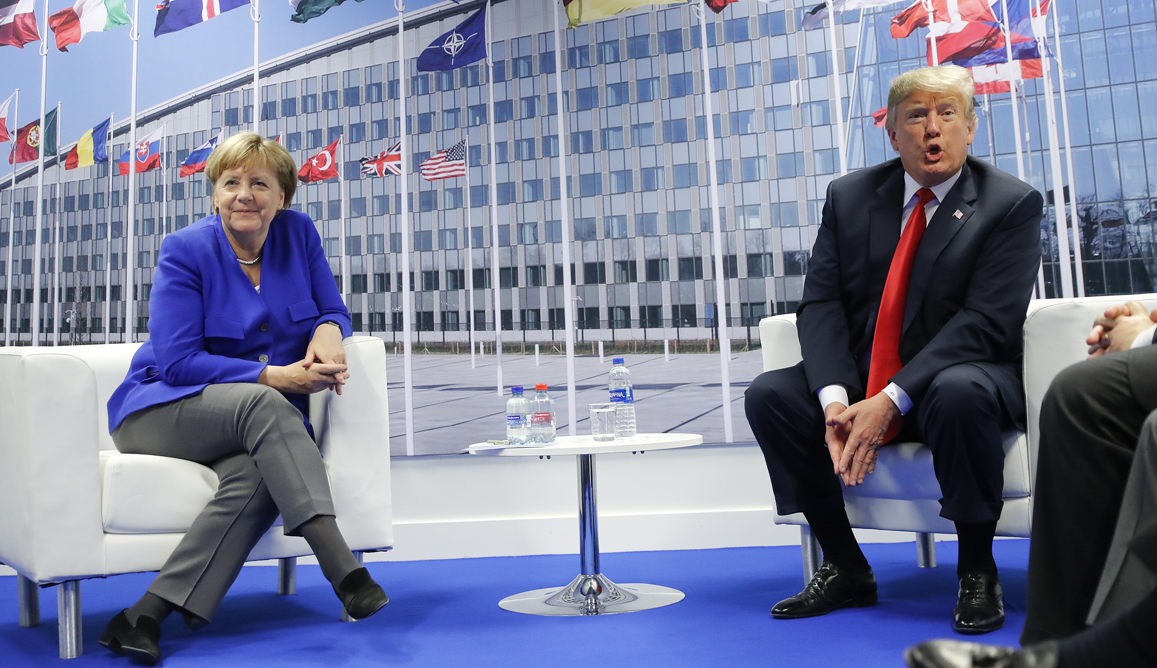 Trump meets Angela Merkel at NATO summit after accusing Germany of ...