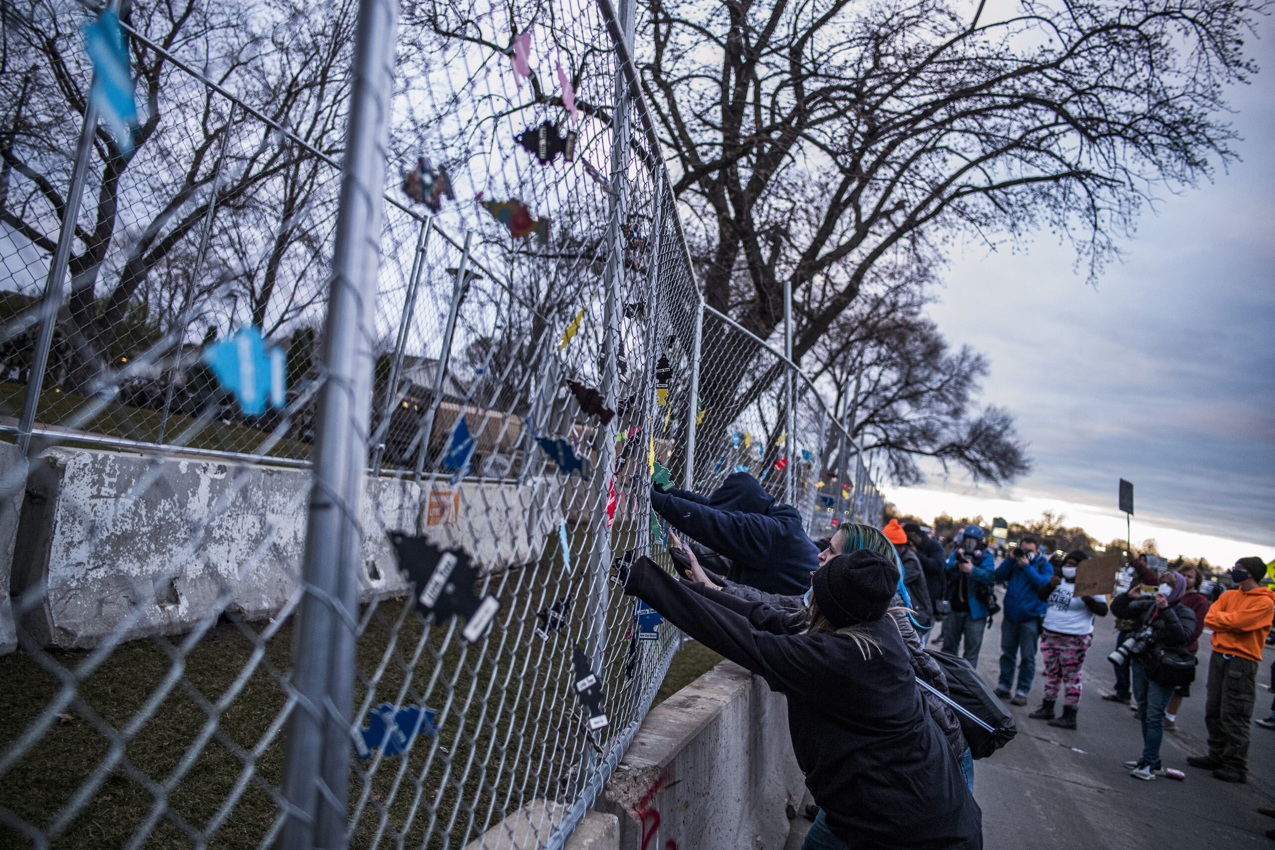 Demonstrators attempt to cut through perimeter fence and hurl objects ...